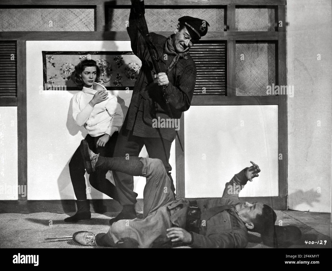 LAUREN BACALL and JOHN WAYNE in BLOOD ALLEY (1955), directed by WILLIAM ...