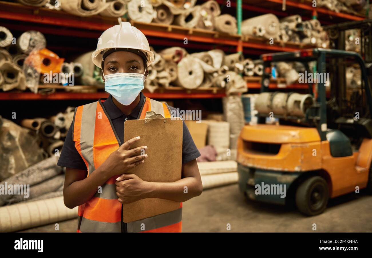 African warehouse worker wearing a face mask Stock Photo - Alamy