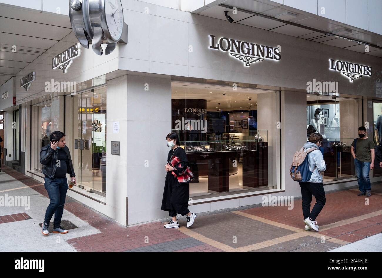 Hong, China. 21st Mar, 2021. Pedestrians walk past the Swiss luxury ...
