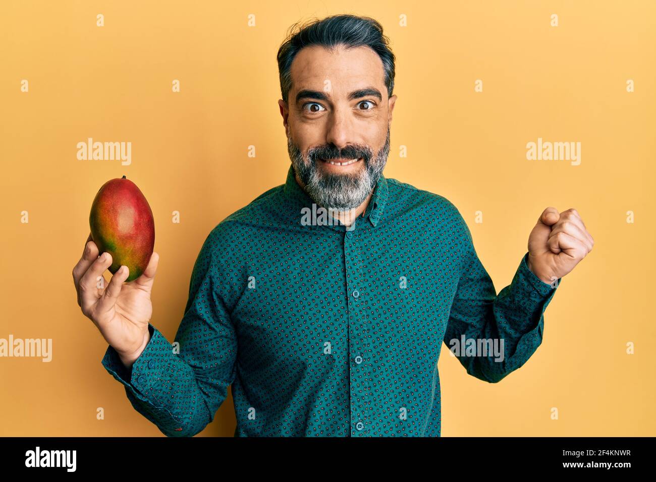 Man with beard eating mango hi-res stock photography and images - Alamy