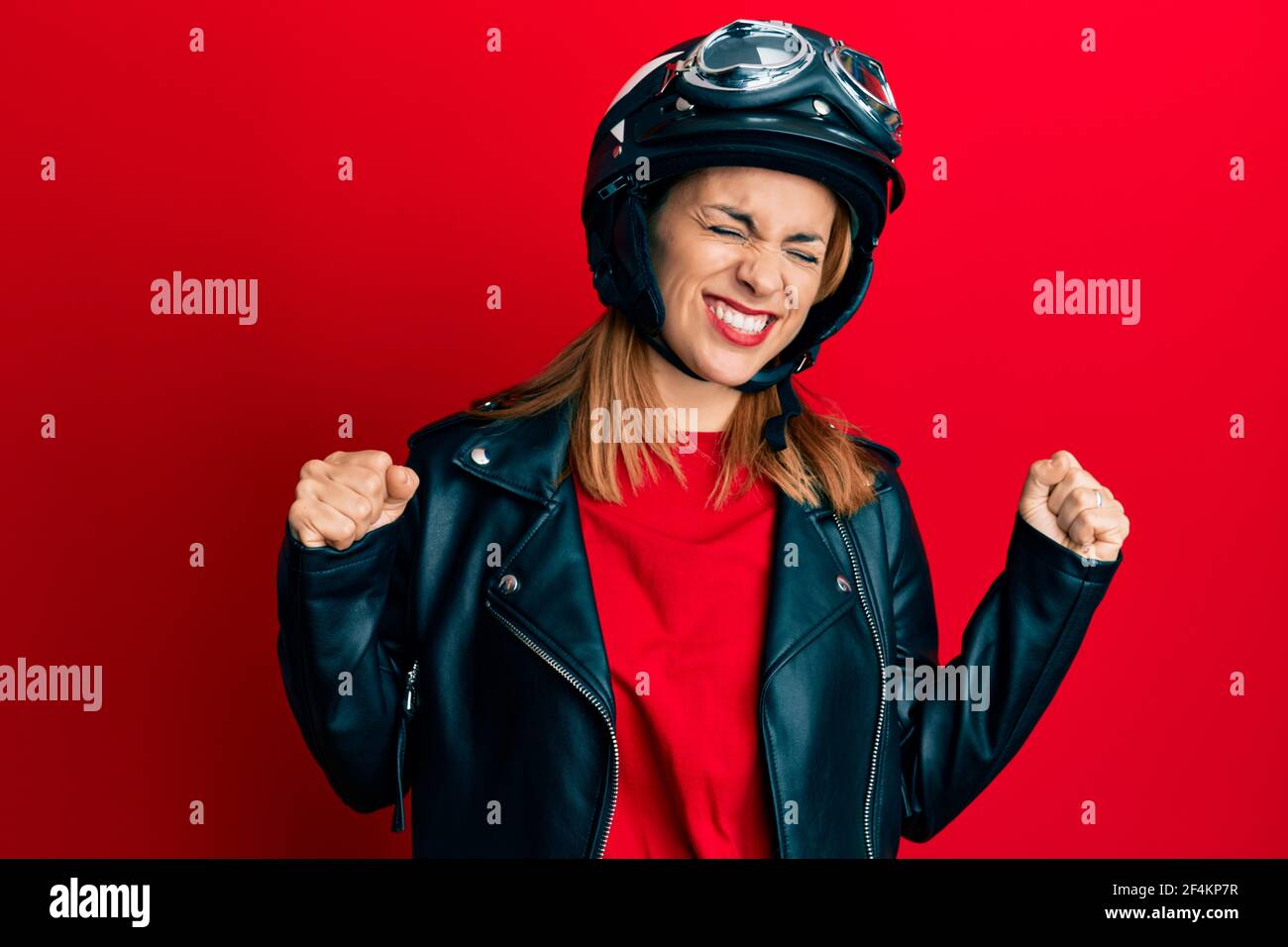 Hispanic young woman wearing motorcycle helmet very happy and excited ...