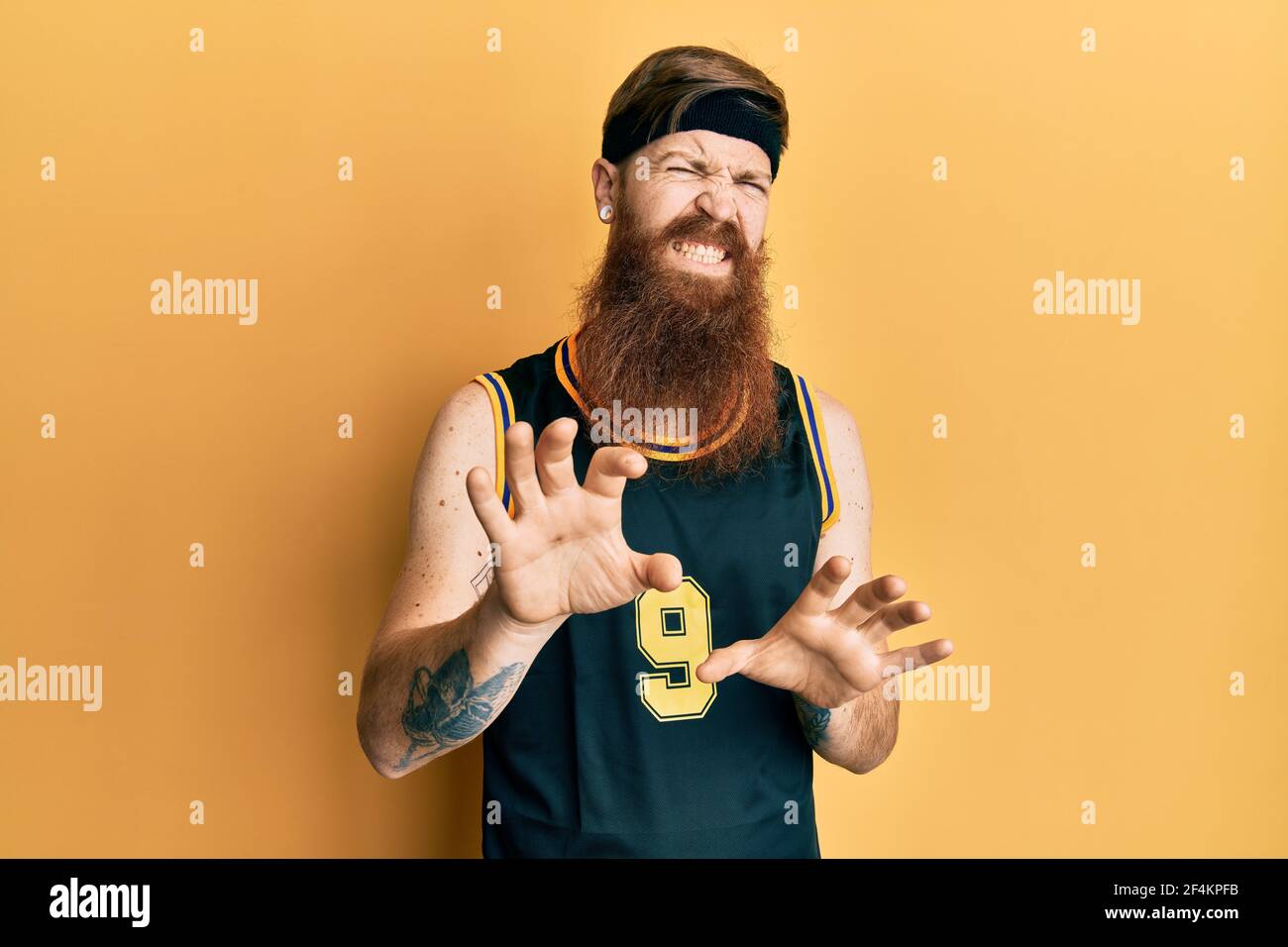 Redhead man with long beard wearing basketball uniform disgusted ...