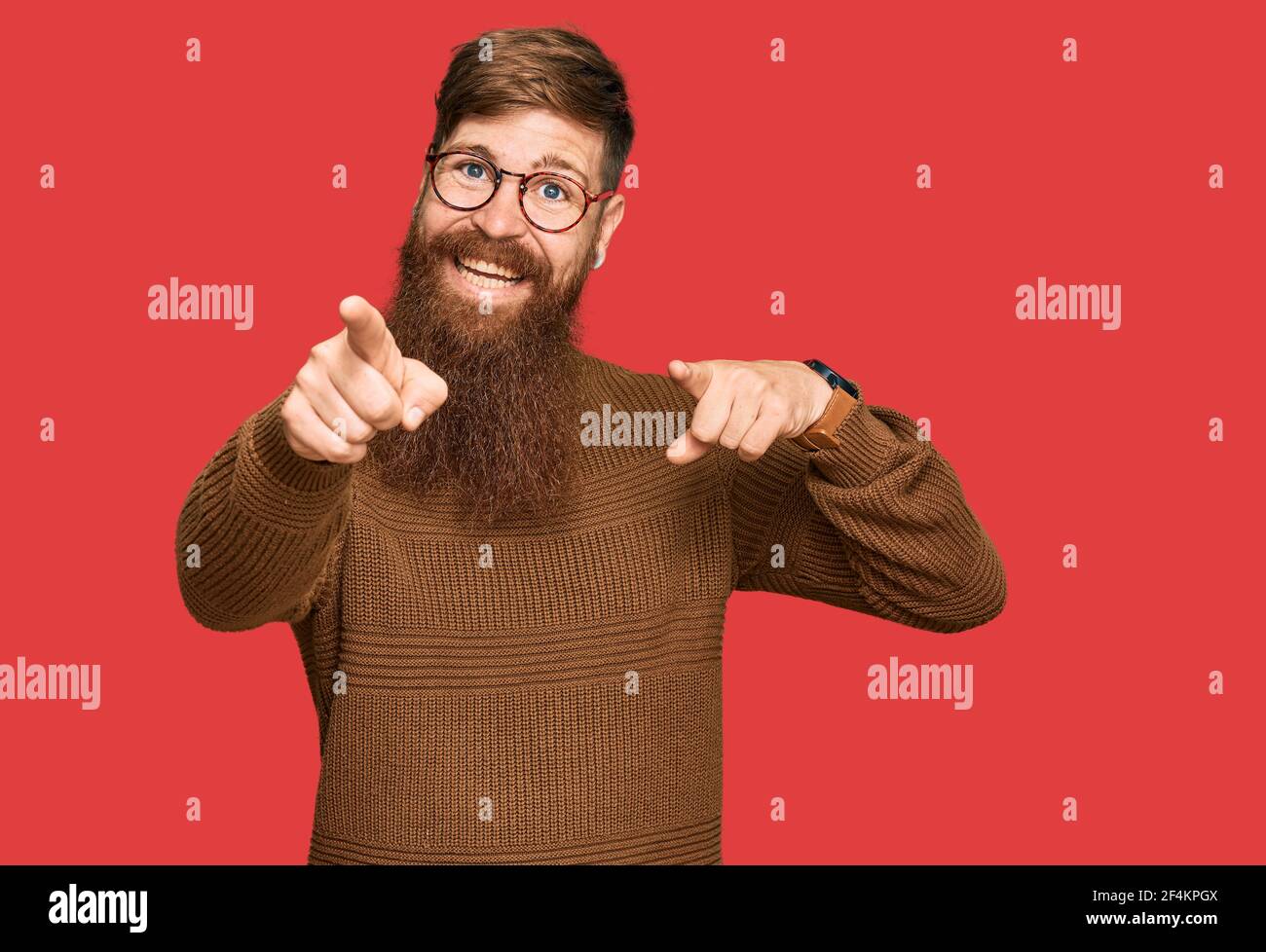 Young irish redhead man wearing casual clothes and glasses pointing to ...
