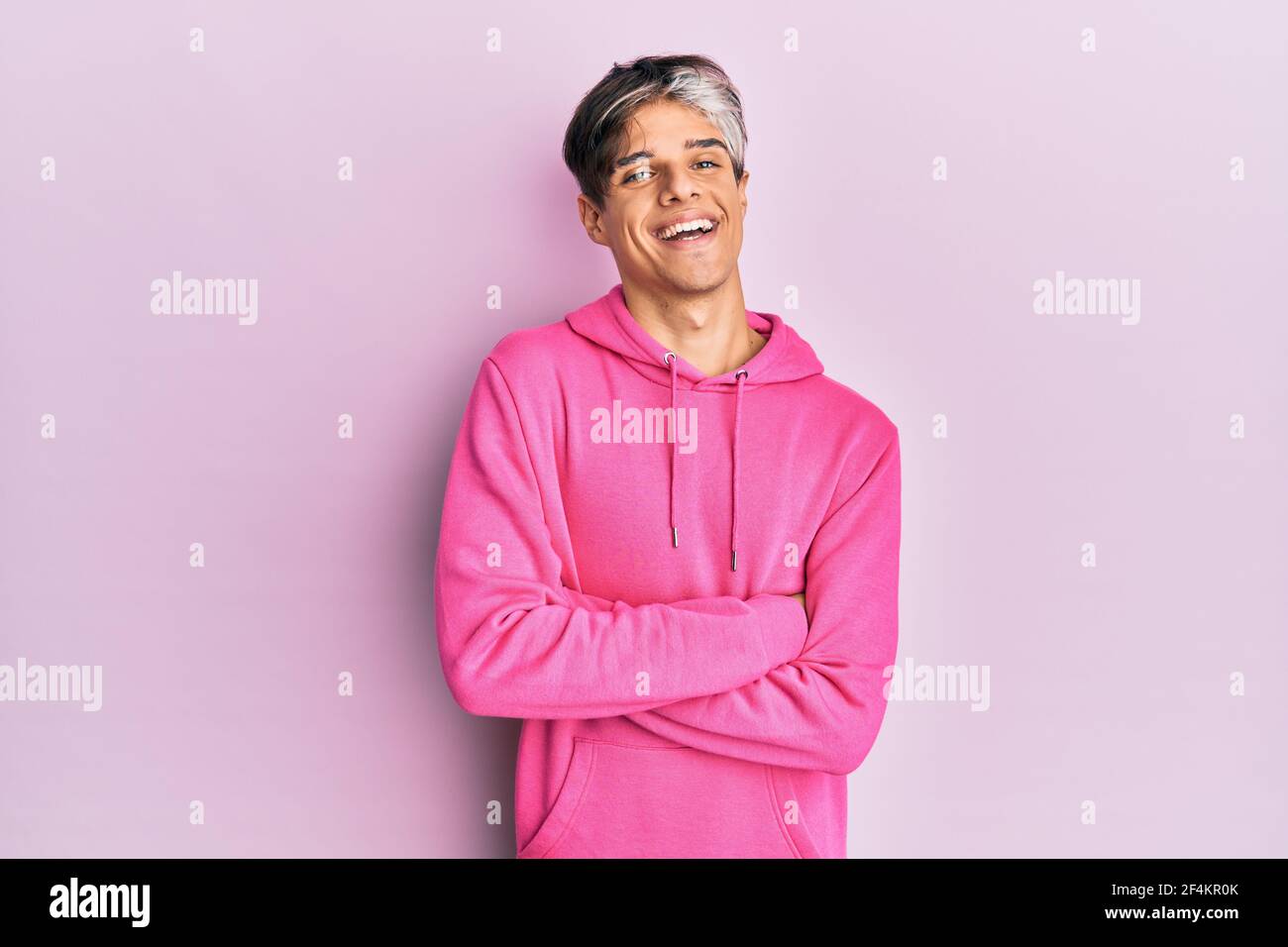 Young hispanic man wearing casual pink sweatshirt happy face smiling ...