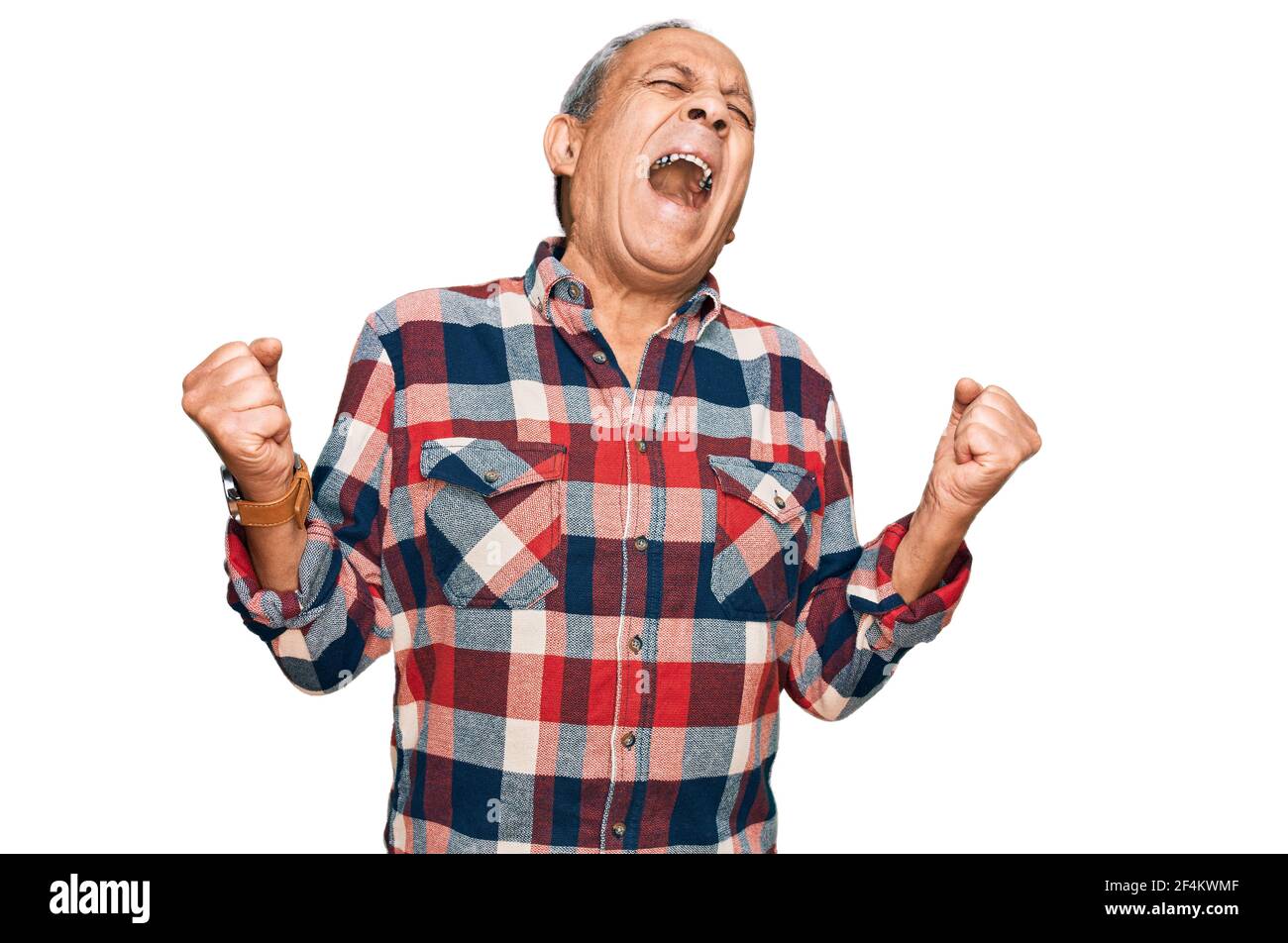 Senior hispanic man wearing casual clothes very happy and excited doing ...