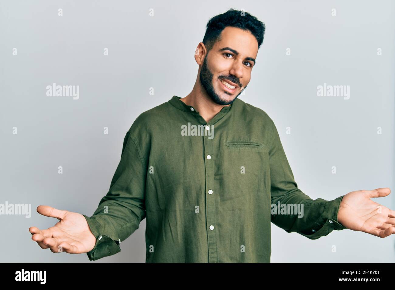 Young hispanic man wearing casual clothes clueless and confused ...