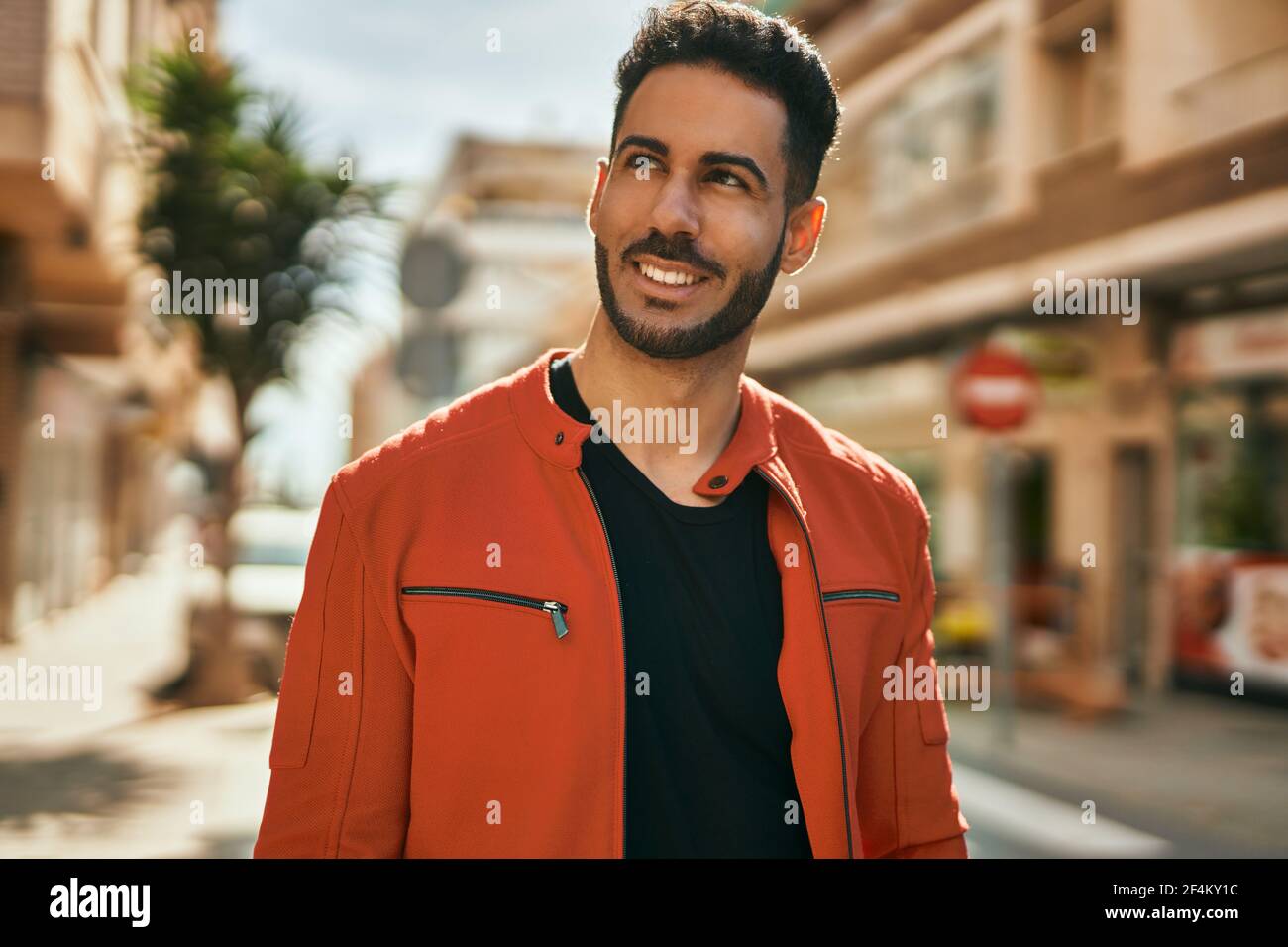 Young hispanic man smiling happy standing at the city Stock Photo - Alamy
