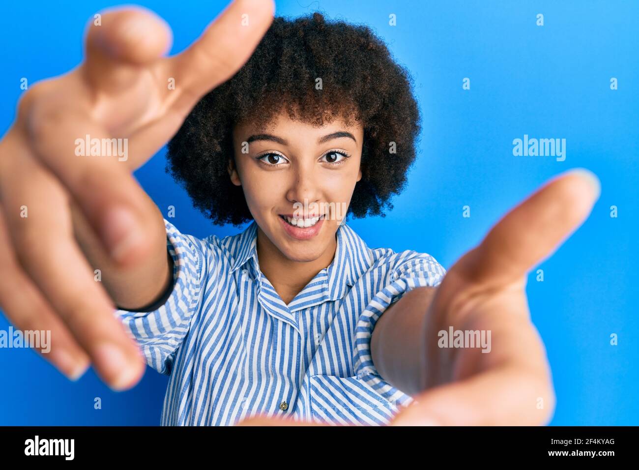 Young hispanic girl wearing casual clothes looking at the camera ...