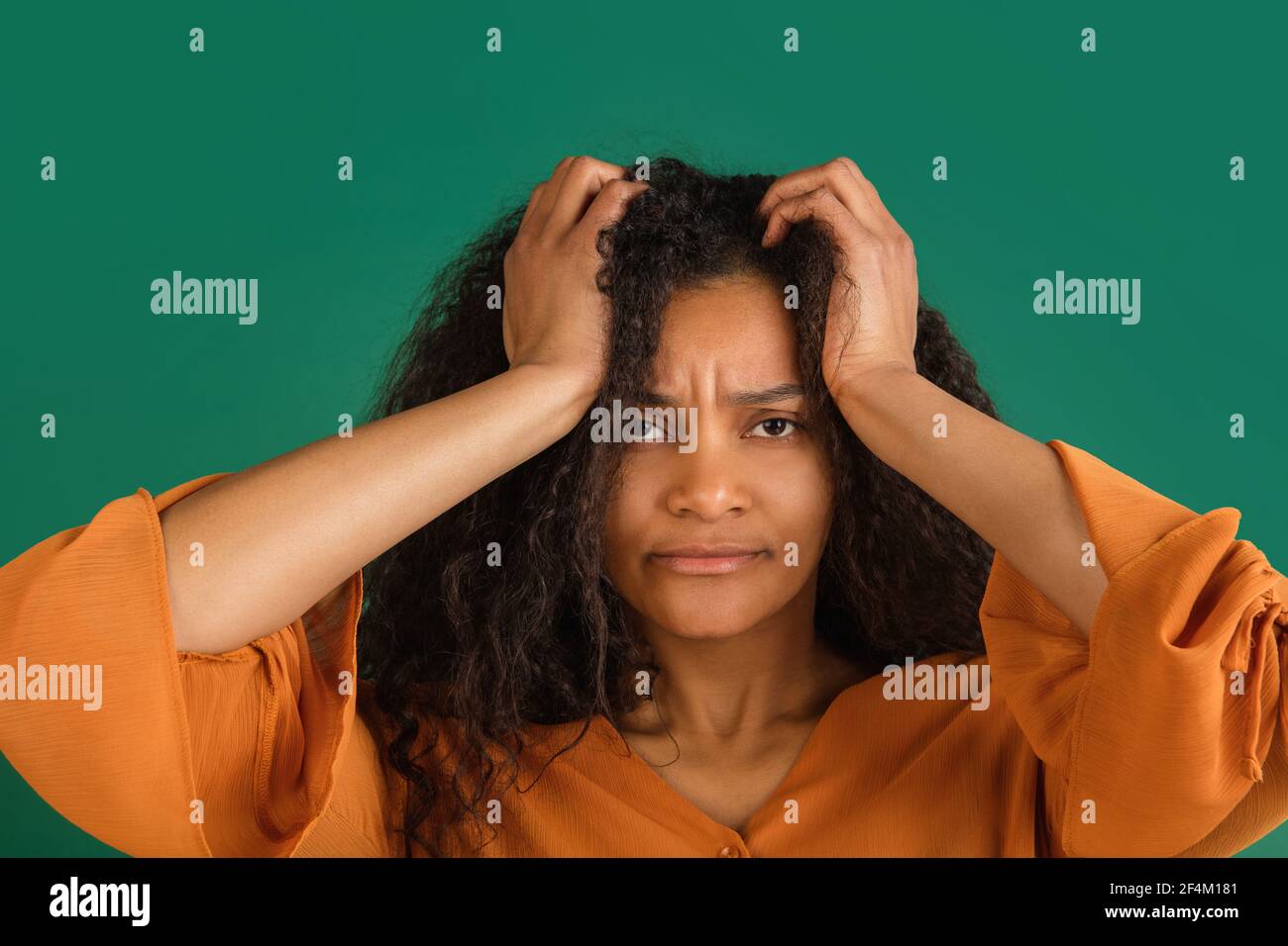 African-american woman portrait isolated on green studio background ...