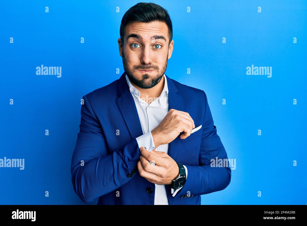 Young hispanic businessman wearing business jacket putting on shirt ...