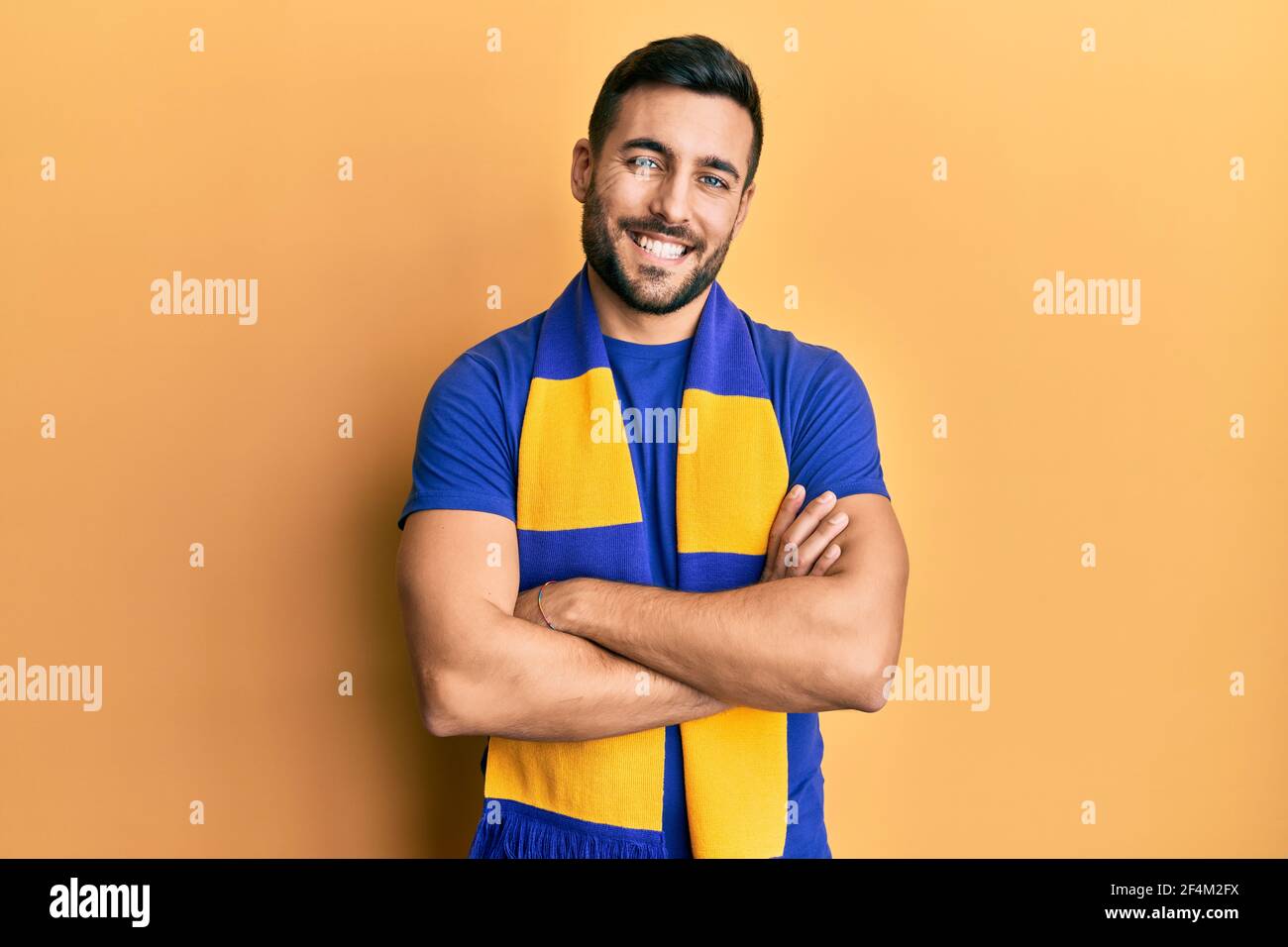 Young hispanic man football hooligan cheering game happy face smiling ...
