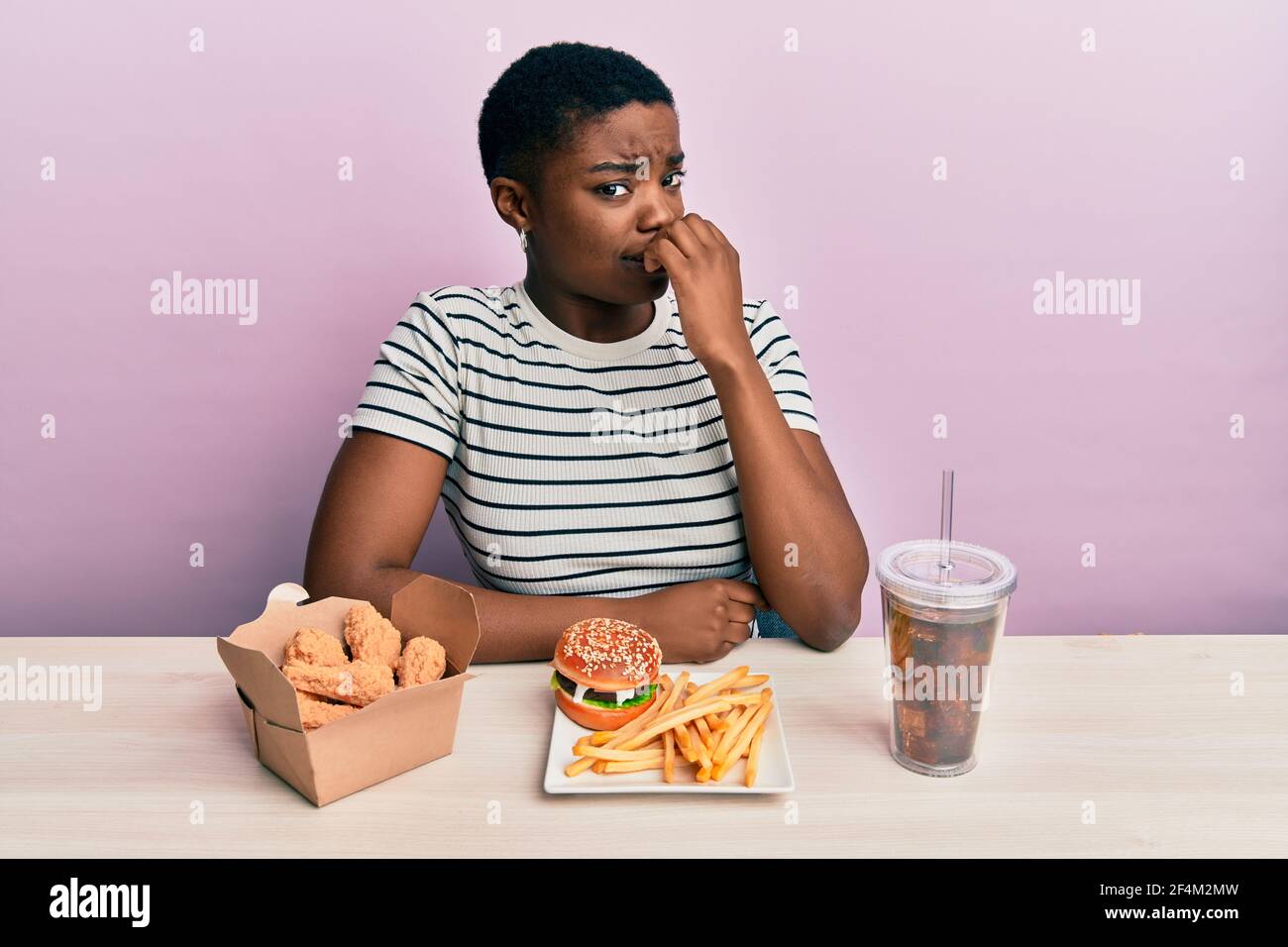 Nervous person eating hamburger hi-res stock photography and images - Alamy