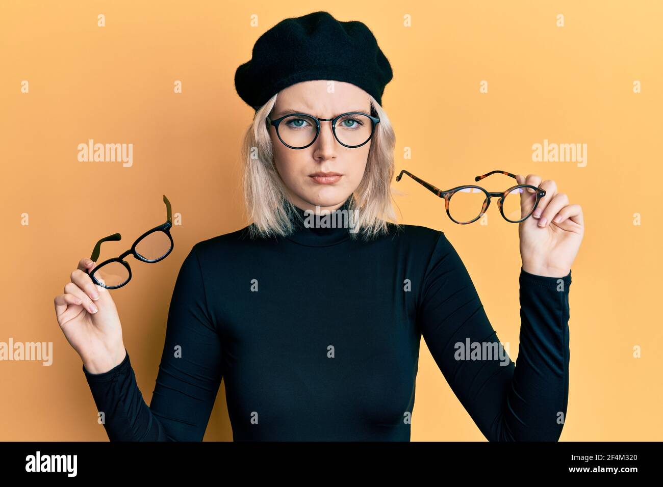 Young blonde girl wearing many glass over face skeptic and nervous ...