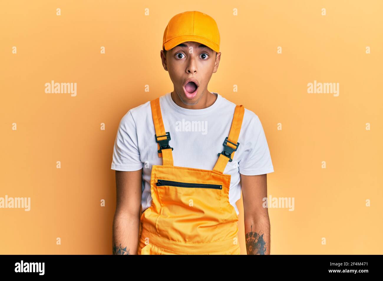 Young handsome african american man wearing handyman uniform over ...