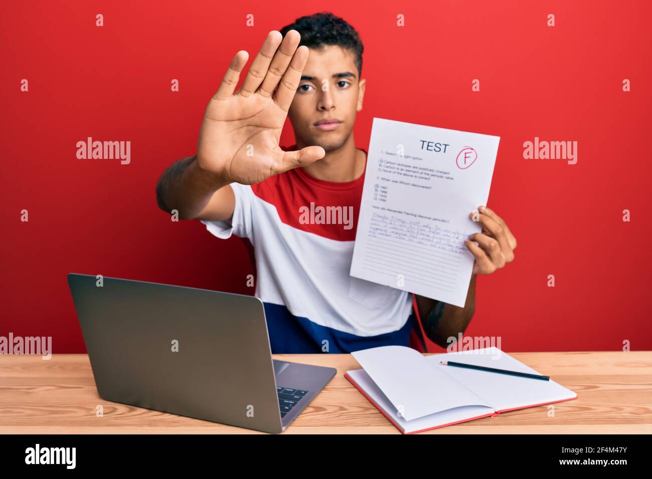 Young handsome african american man showing failed exam with open hand ...