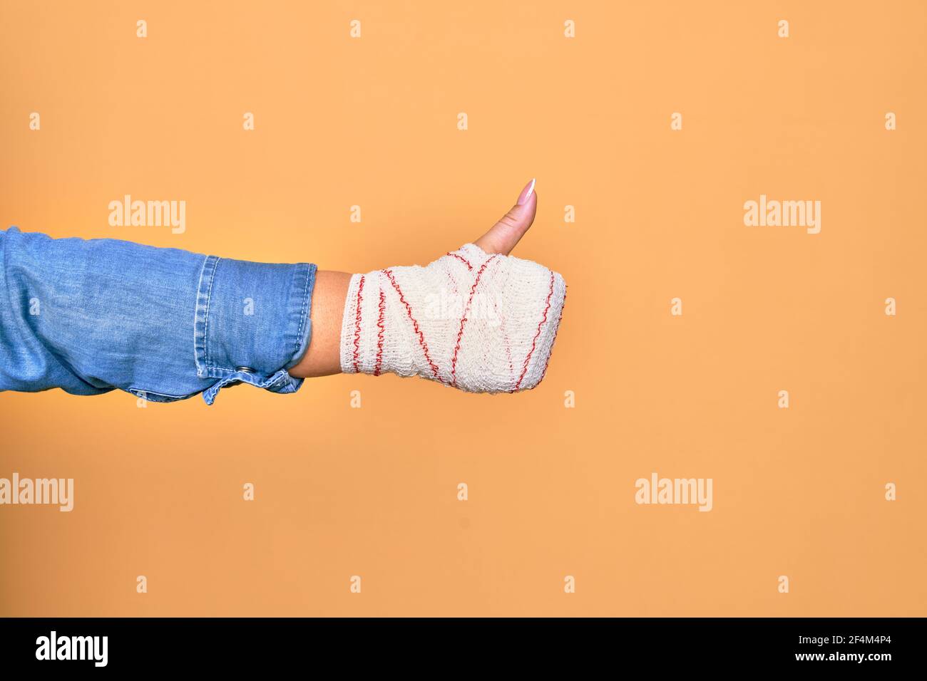 Wounded hand of caucasian young woman cover with bandage doing ok sign ...
