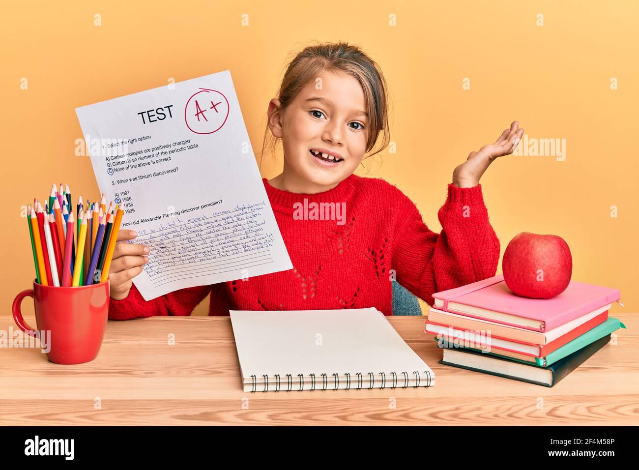 Little beautiful girl showing a passed exam celebrating achievement ...