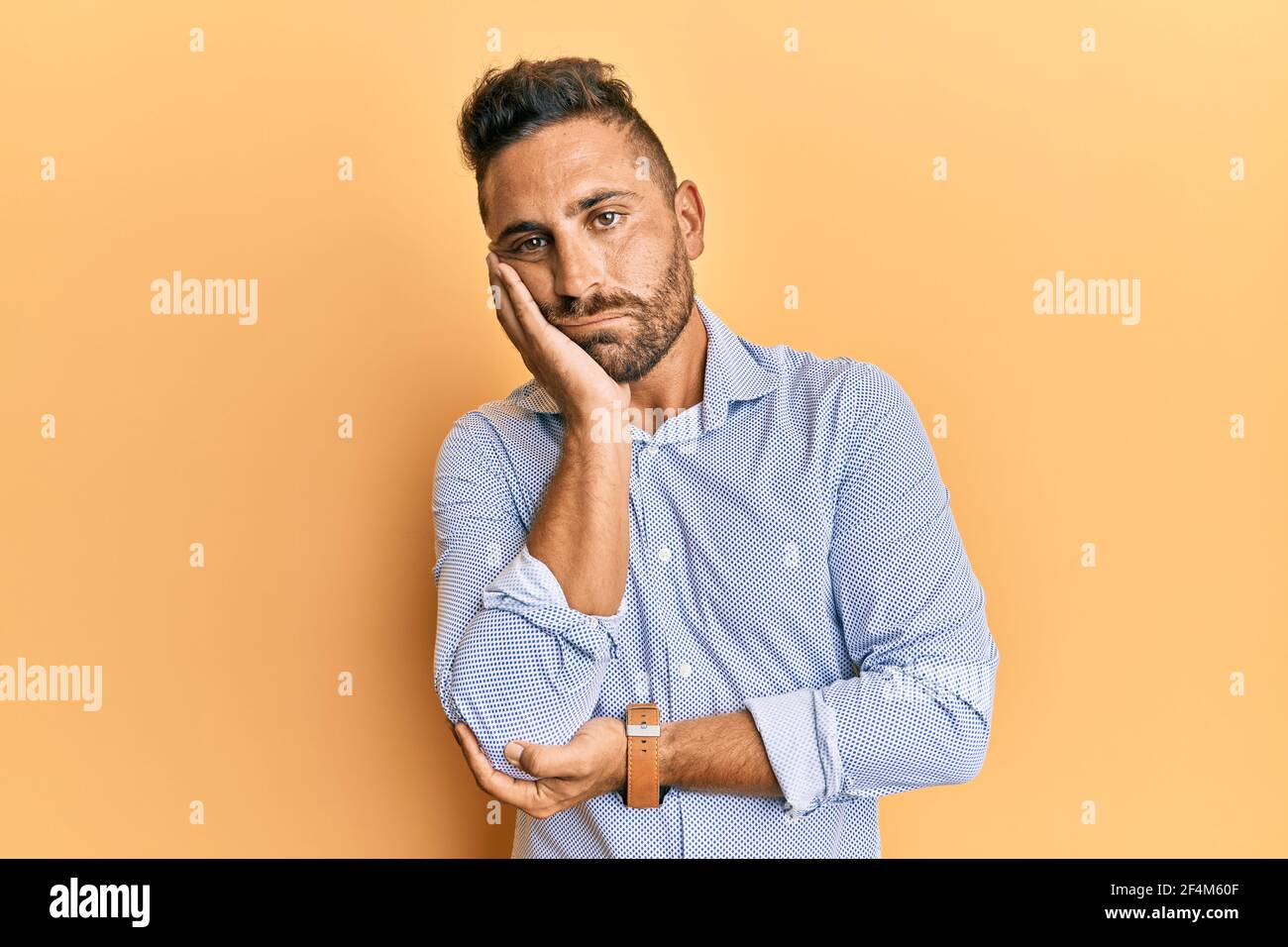 Handsome man with beard wearing casual clothes thinking looking tired ...