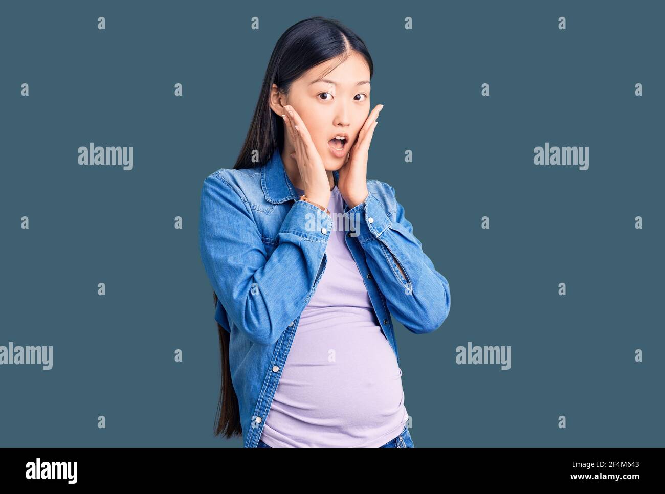 Young beautiful chinese woman pregnant expecting baby afraid and ...