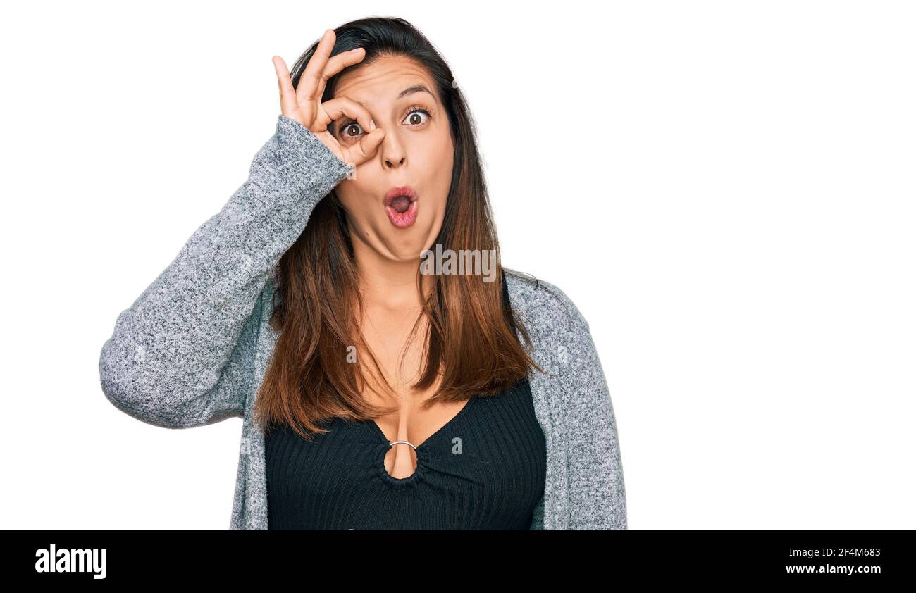 Beautiful hispanic woman wearing casual clothes doing ok gesture ...