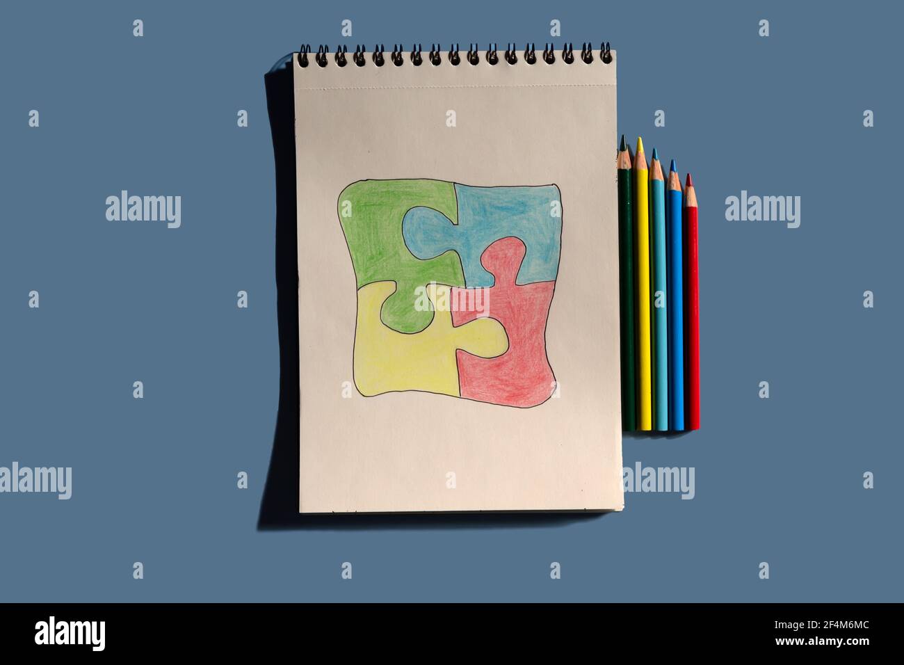 Autism awareness day or month. The drawn puzzle is colored in different ...