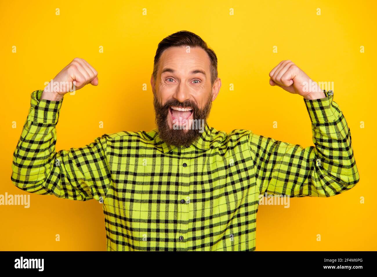 Photo of cheerful sportive man happy positive smile show arms muscles ...