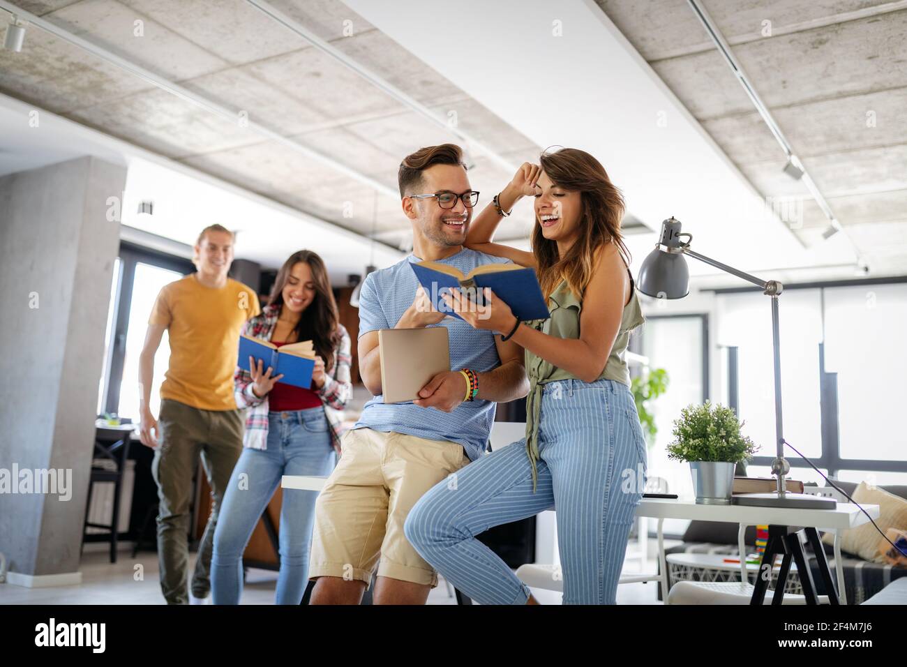 Happy group of young students studying together Stock Photo - Alamy