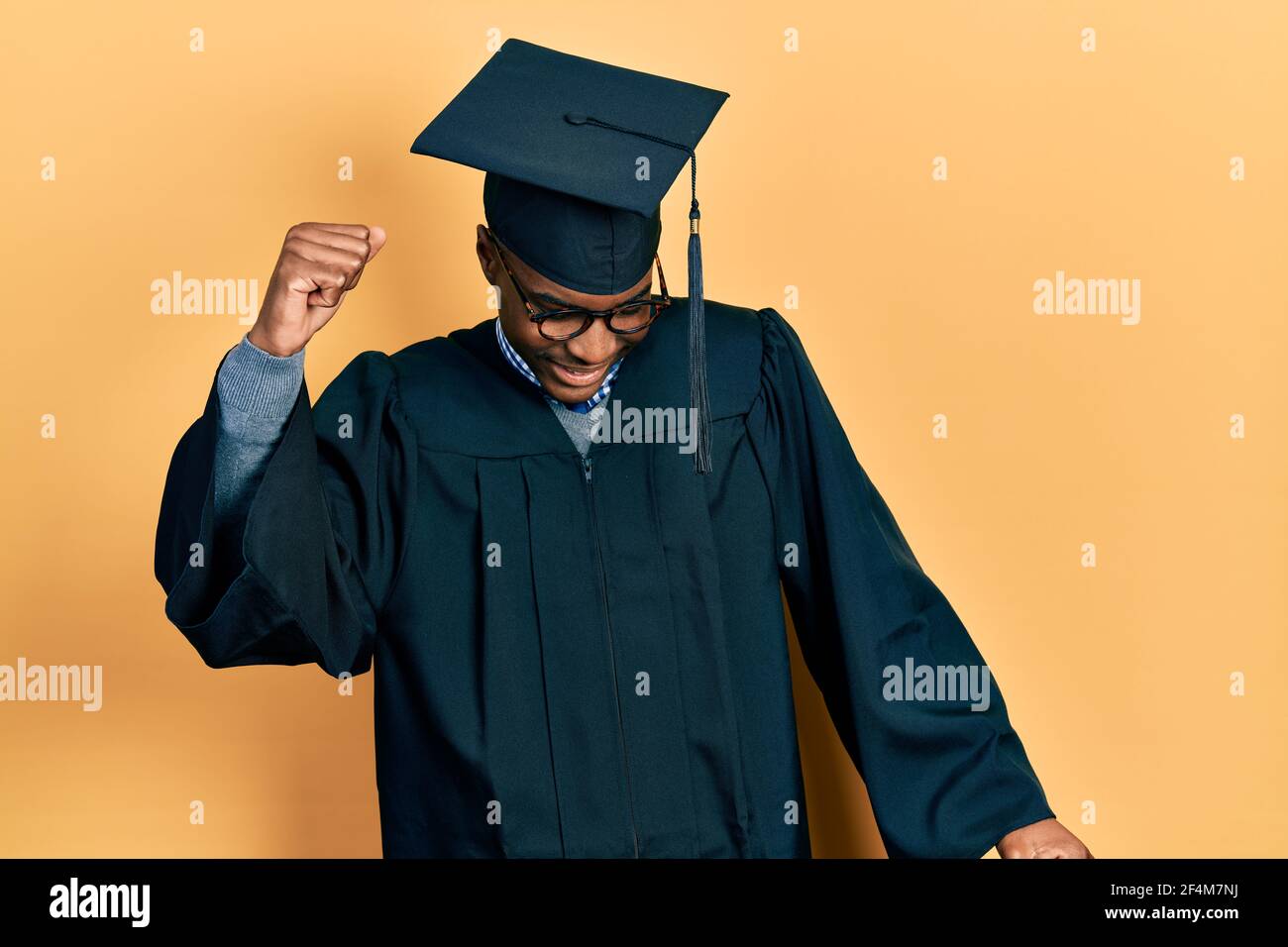 Happy student celebrating graduation dancing hi-res stock photography ...