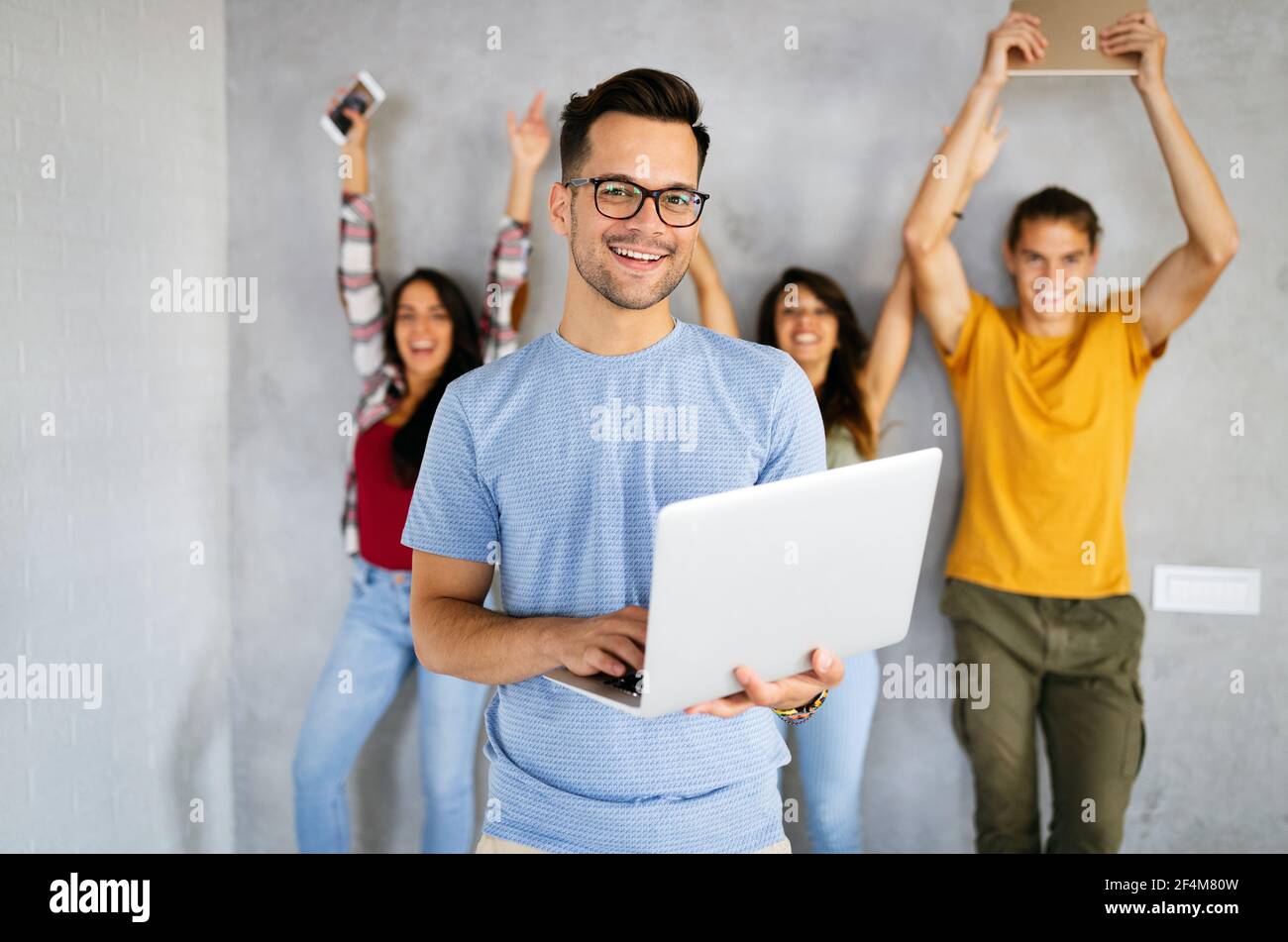 Education, technology and people concept. Happy group of friends using ...