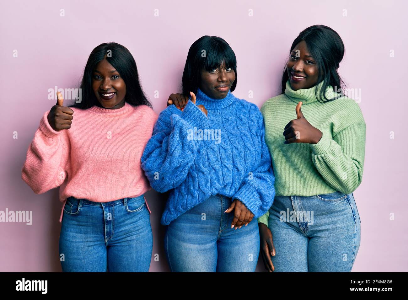 Three young african american friends wearing wool winter sweater doing ...
