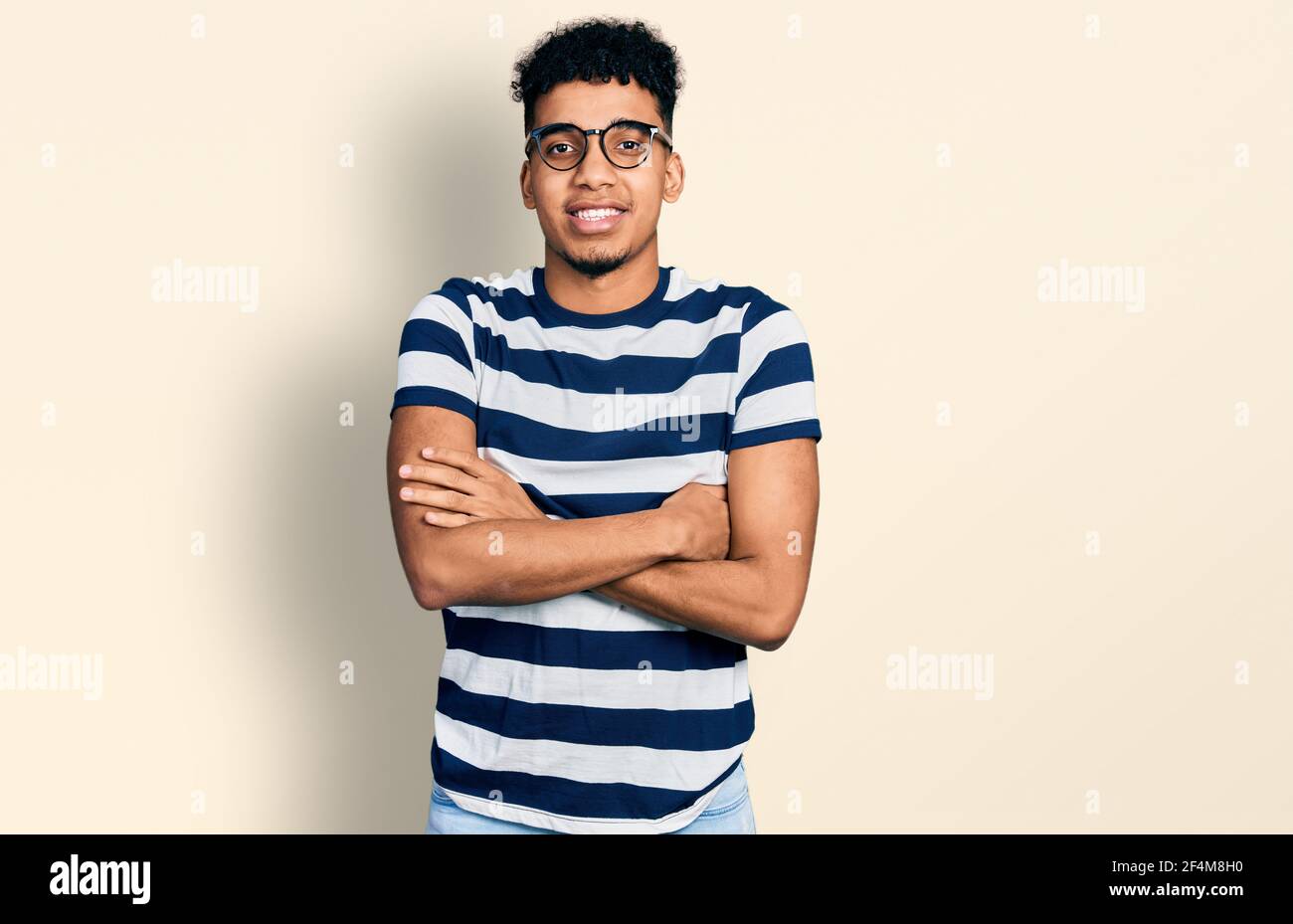 Young african american man wearing casual clothes and glasses happy ...