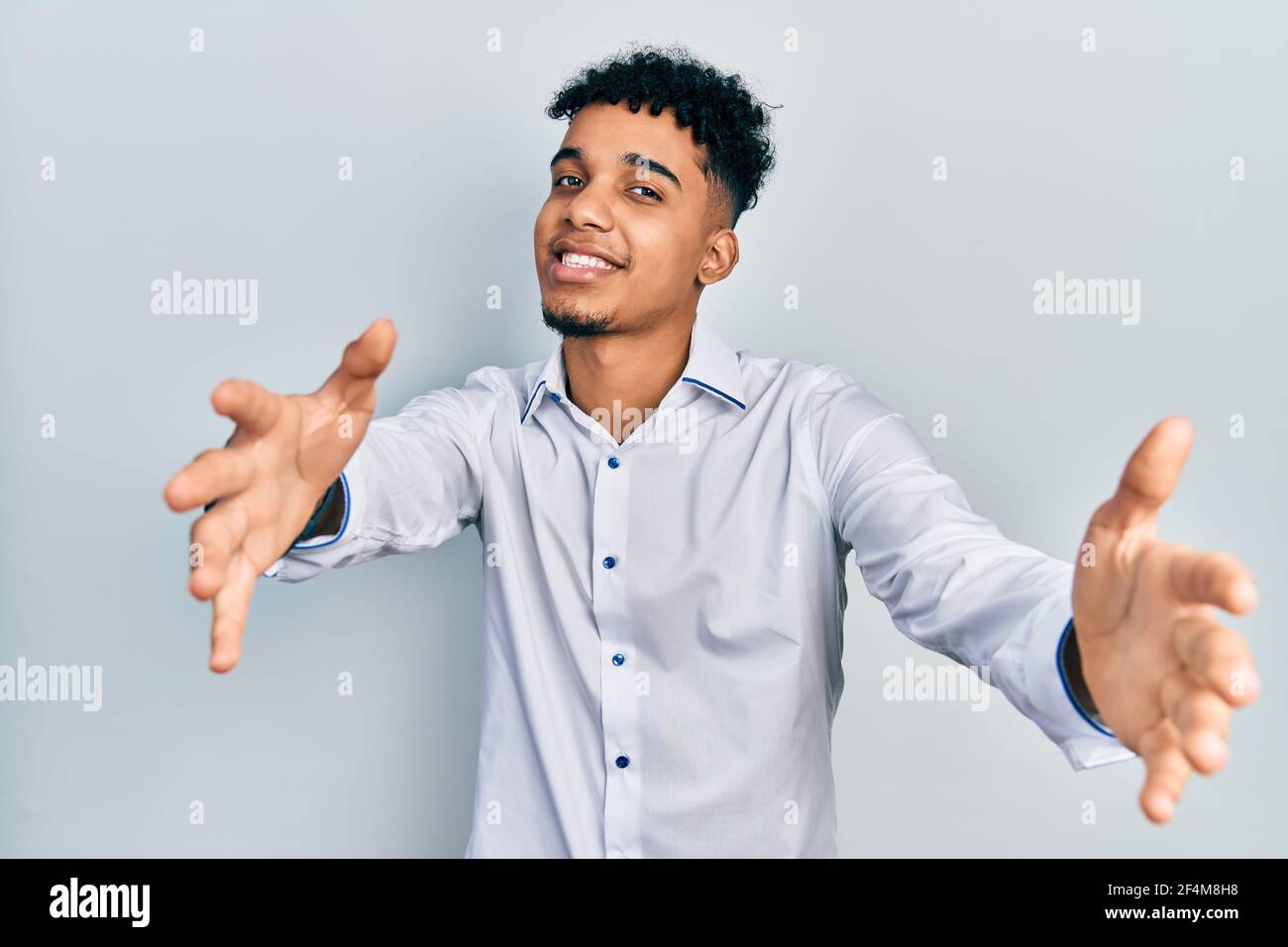 Young african american man wearing business shirt looking at the camera ...