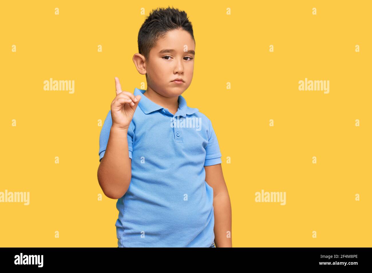 Little boy hispanic kid wearing casual clothes pointing with finger up ...