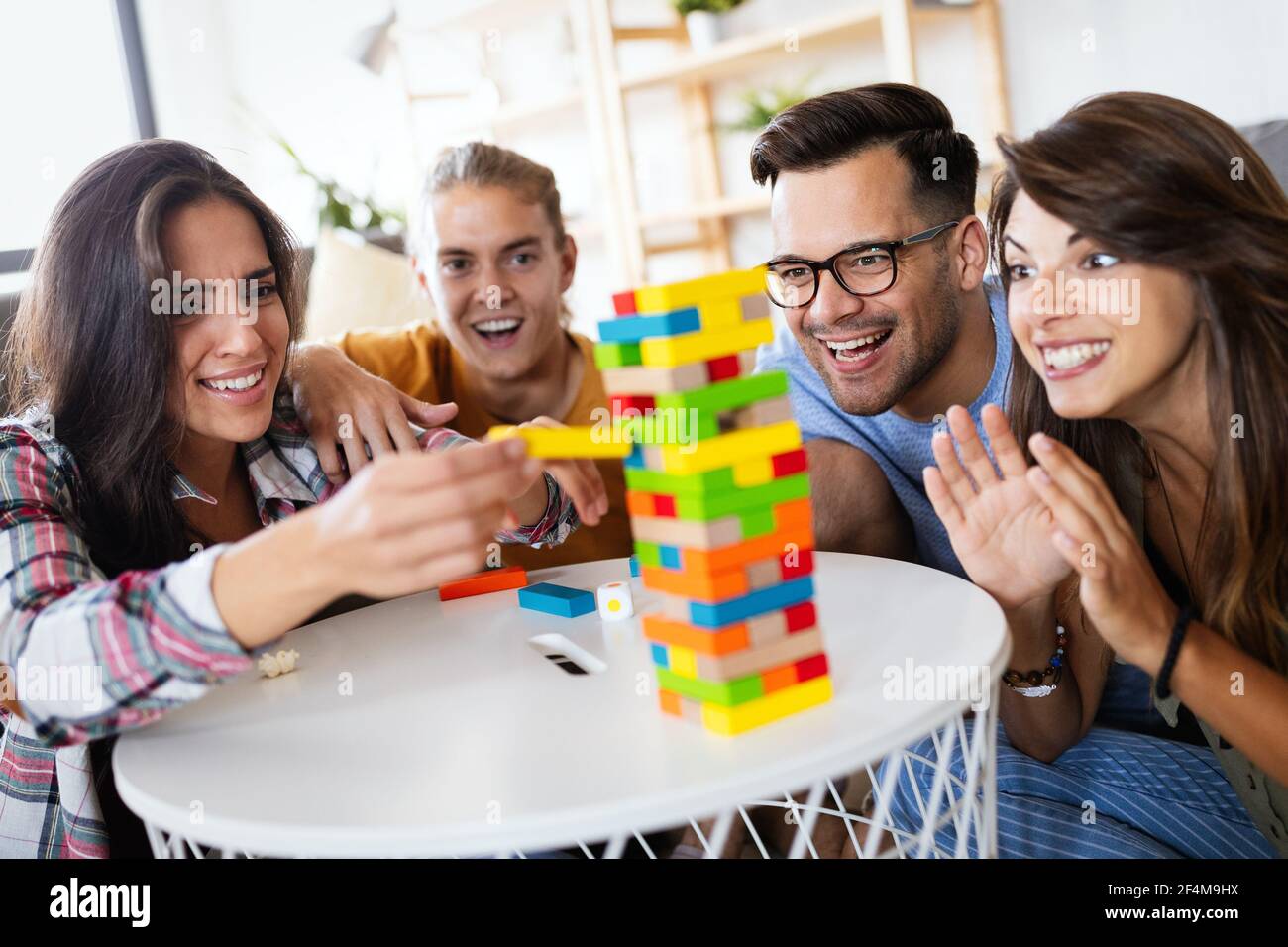 Happy group of friends have fun and playing board game together Stock ...