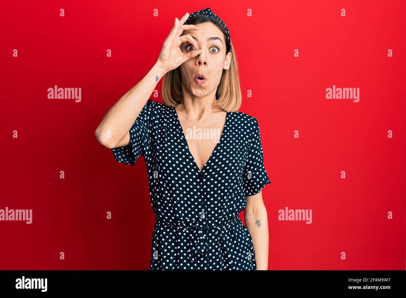 Young caucasian blonde woman wearing beautiful black and white dress ...