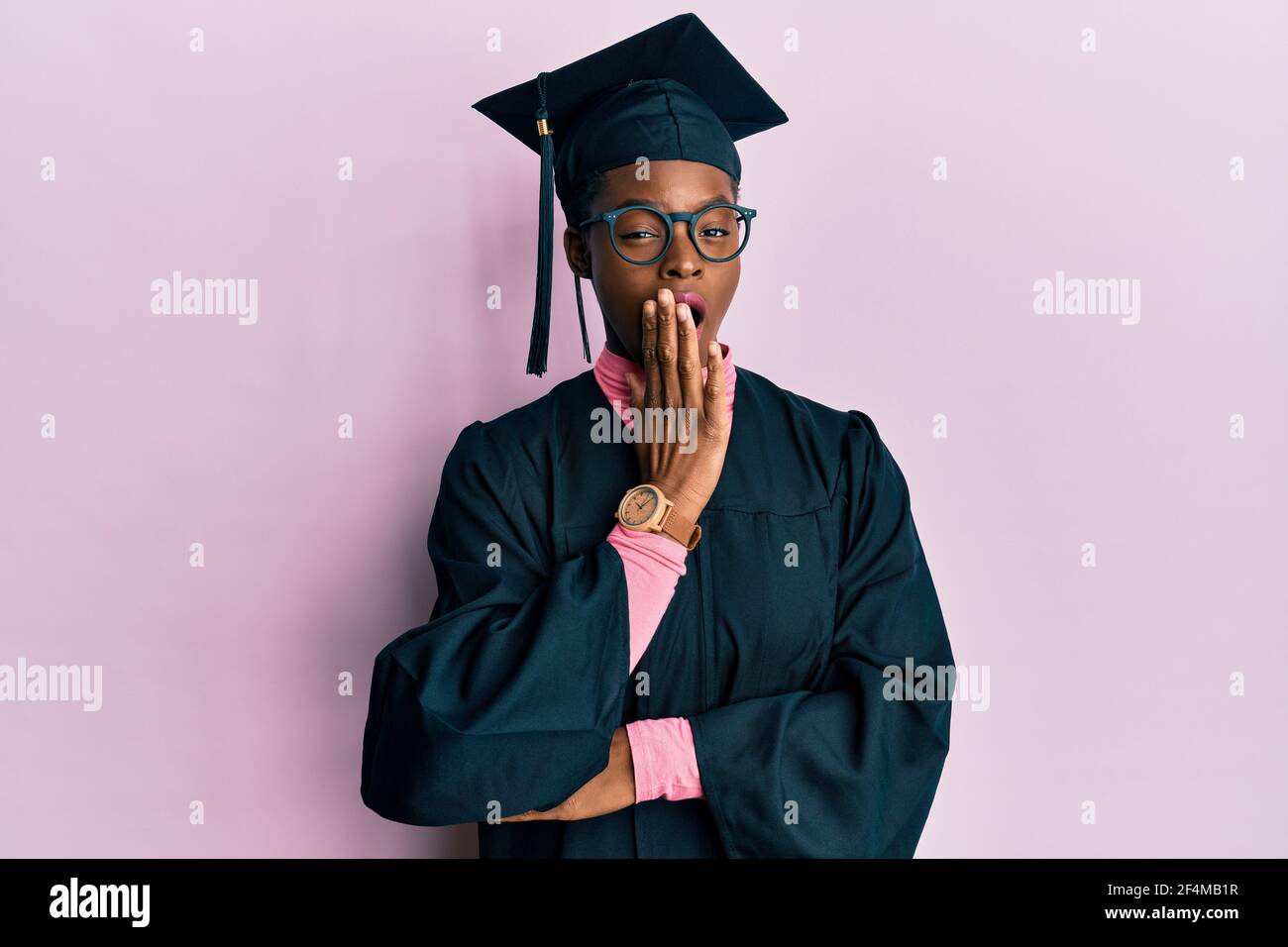 Young african american girl wearing graduation cap and ceremony robe ...