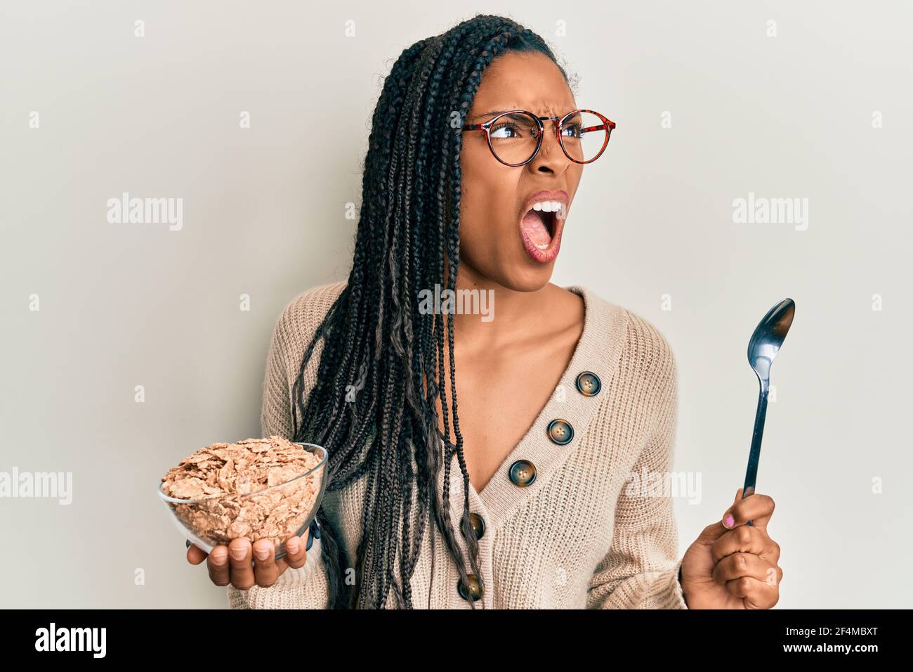 African american woman with braids eating healthy whole grain cereals ...