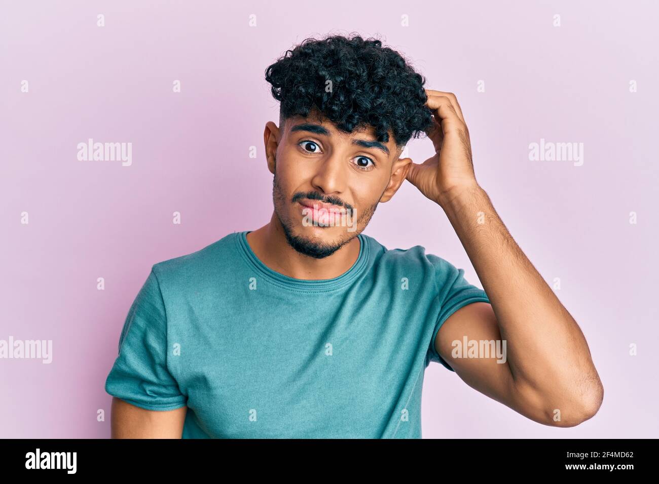 Young Arab Handsome Man Wearing Casual Clothes Confuse And Wonder About
