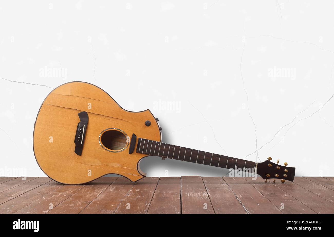 Musical instrument - Front view broken acoustic guitar on a white wall ...