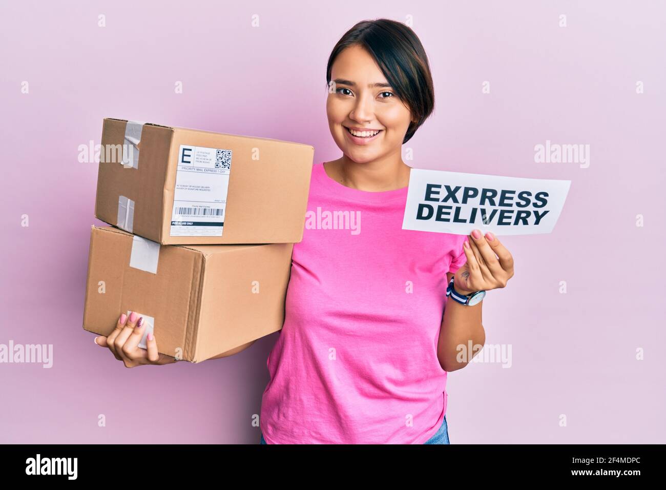 Beautiful young woman with short hair holding delivery box with express ...