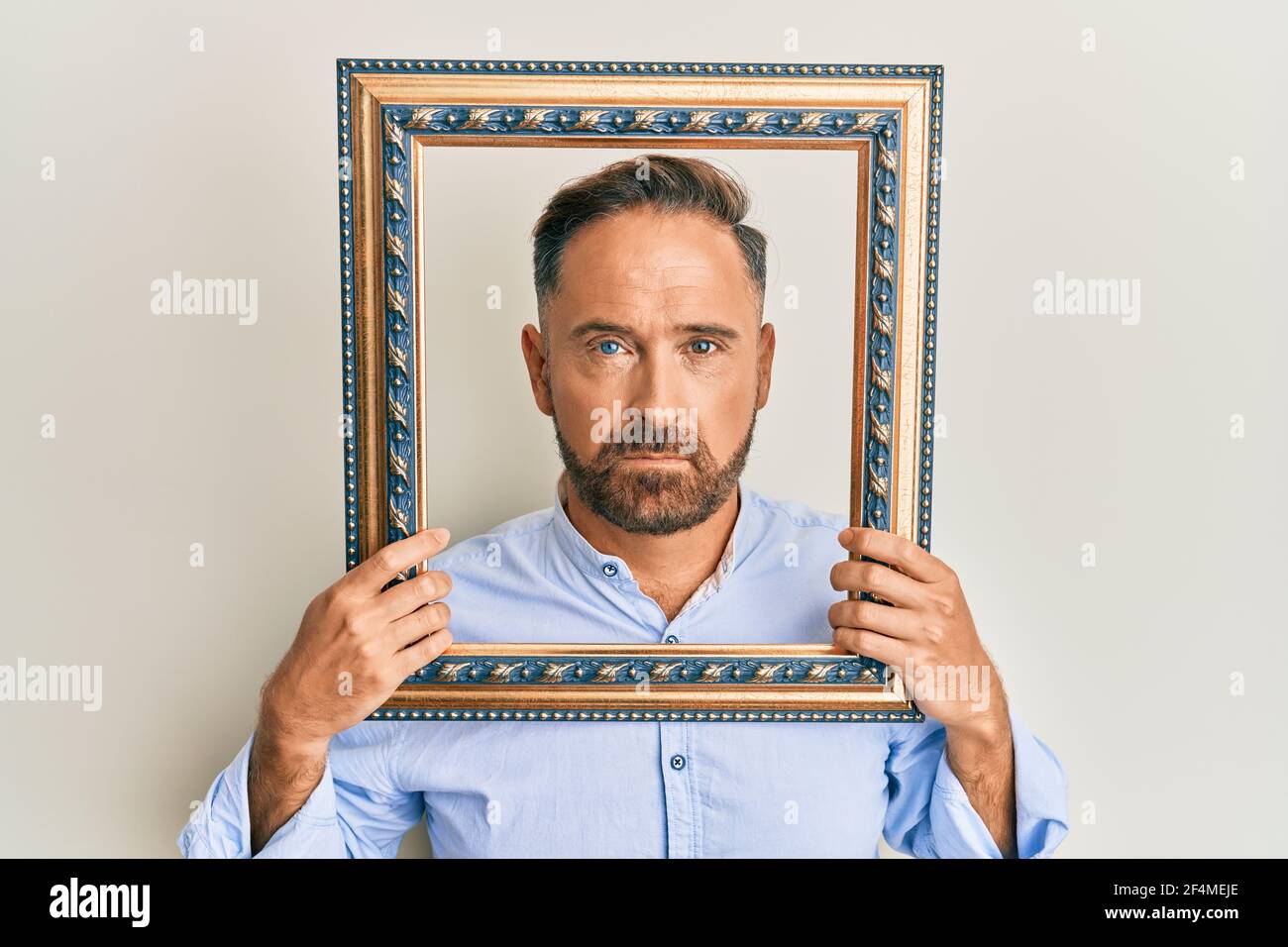 Handsome middle age man holding blank empty banner depressed and worry ...