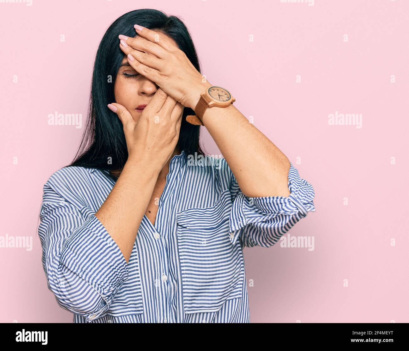 Young caucasian woman wearing casual clothes covering eyes and mouth ...