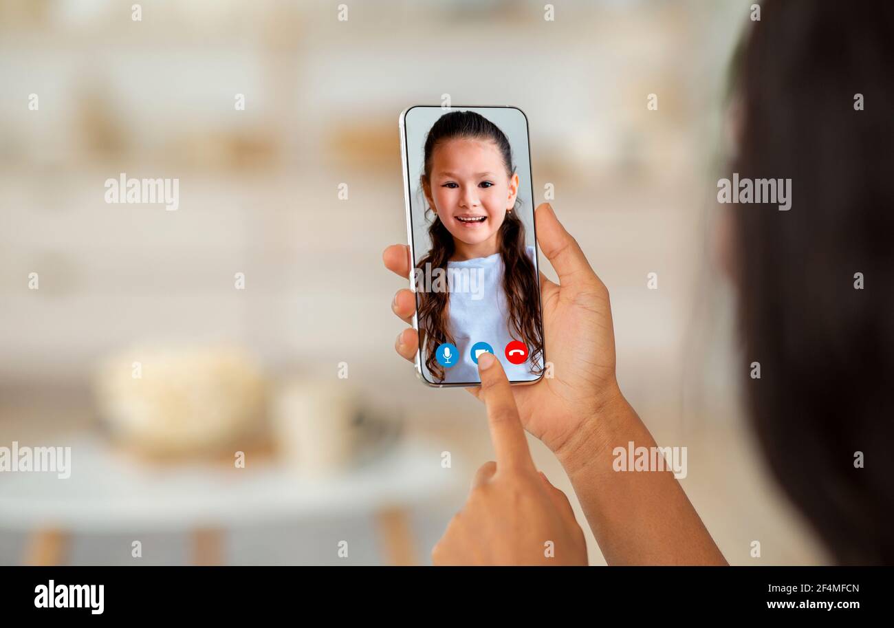Mother talking to her daughter via video call on smartphone Stock Photo ...