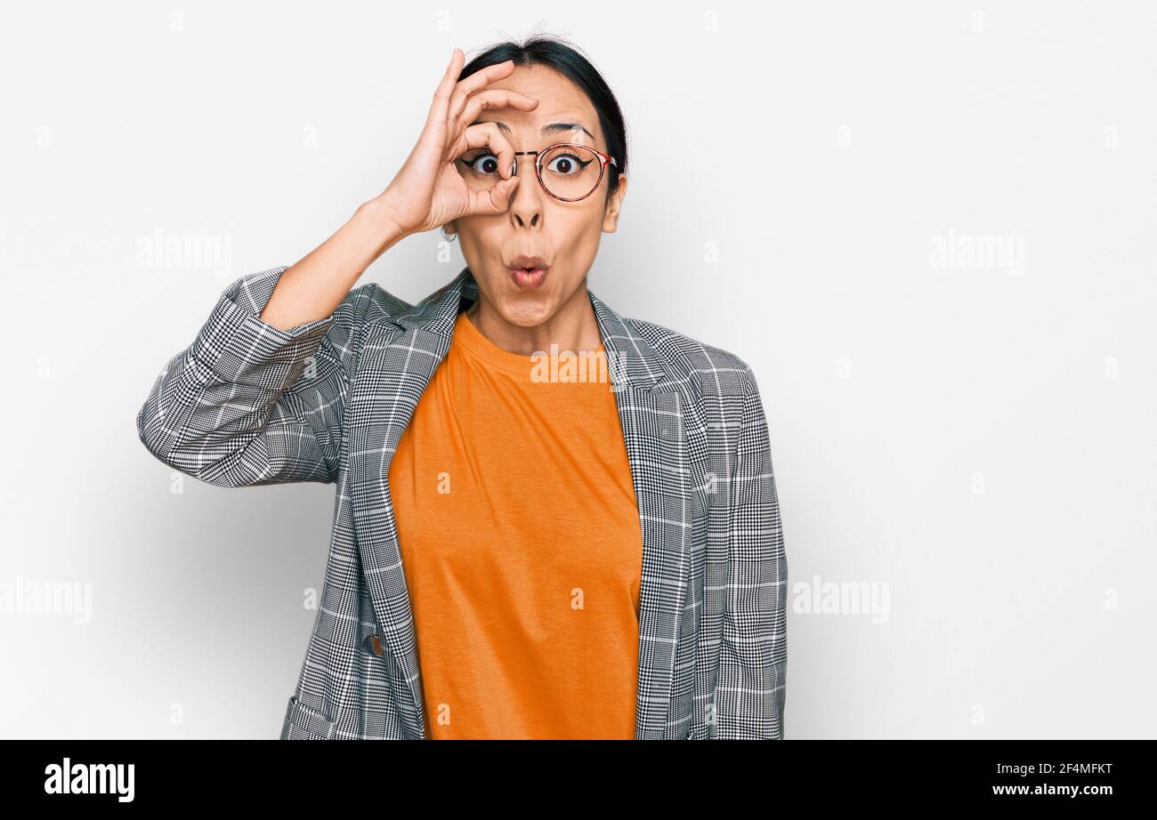 Young hispanic girl wearing business jacket and glasses doing ok ...