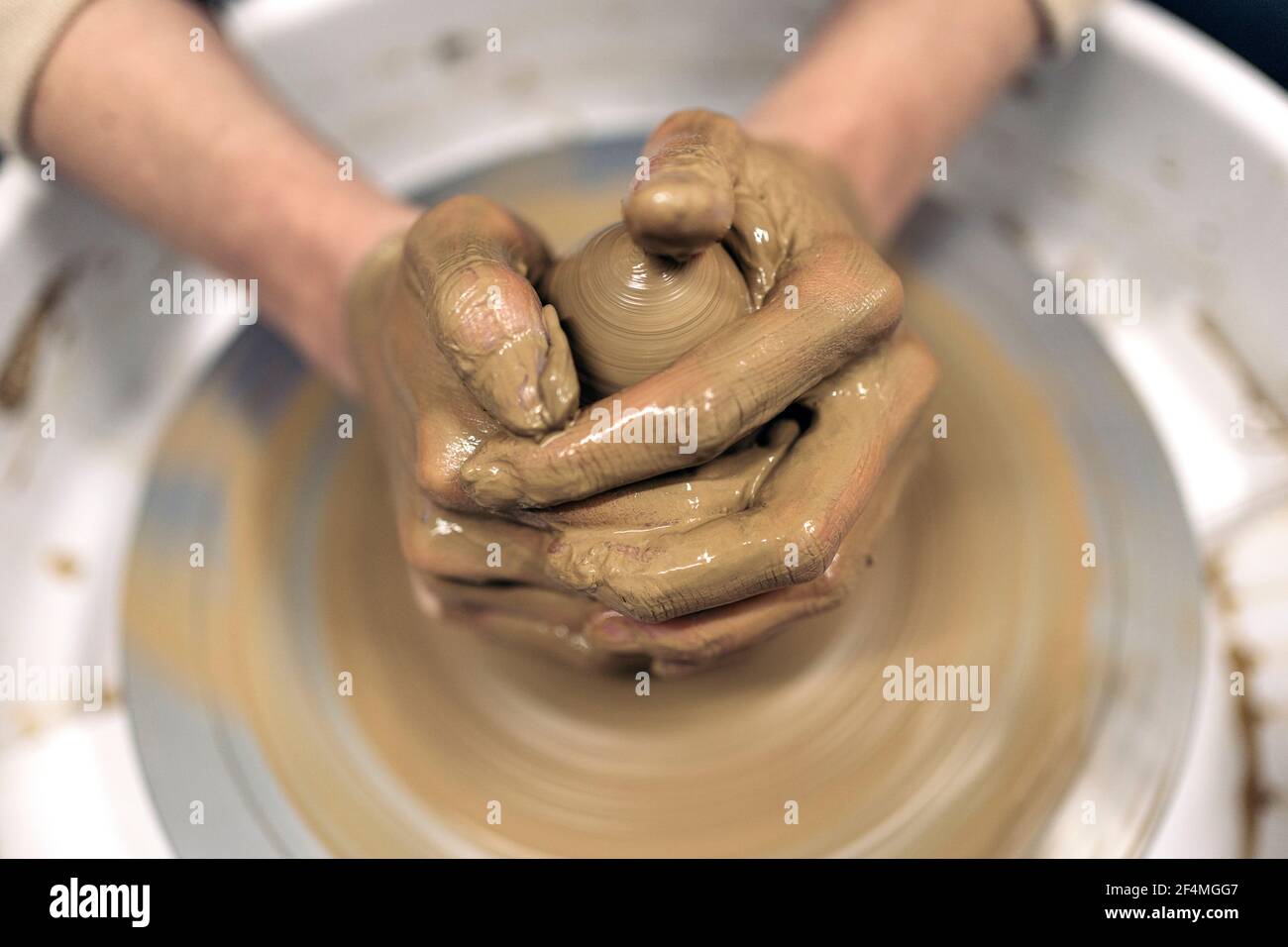 Stock photo of unrecognized person using potter's wheel during pottery ...
