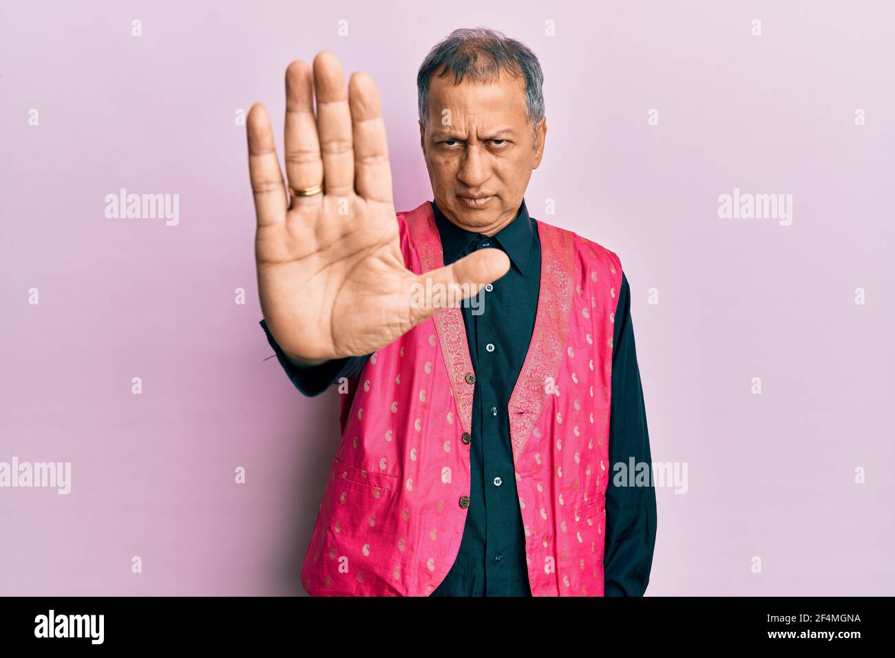 Middle age indian man wearing traditional indian clothes doing stop ...
