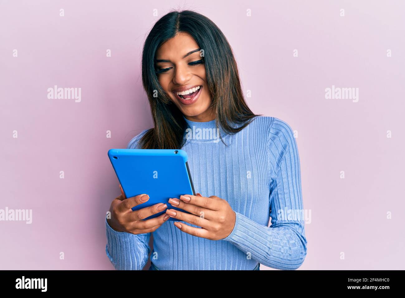 Young Latin Transsexual Transgender Woman Using Touchpad Device Smiling