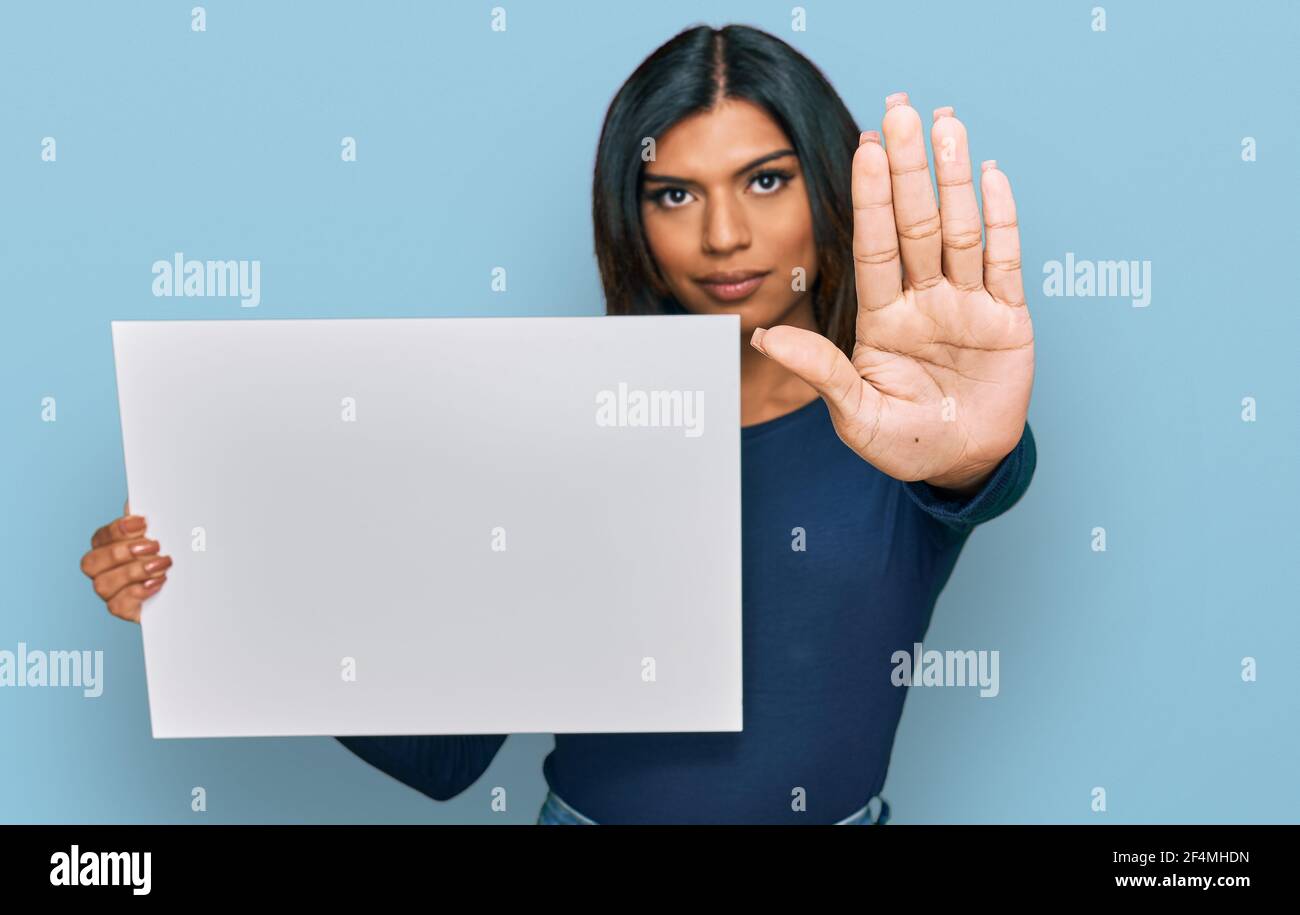 Young latin transsexual transgender woman holding blank empty banner ...