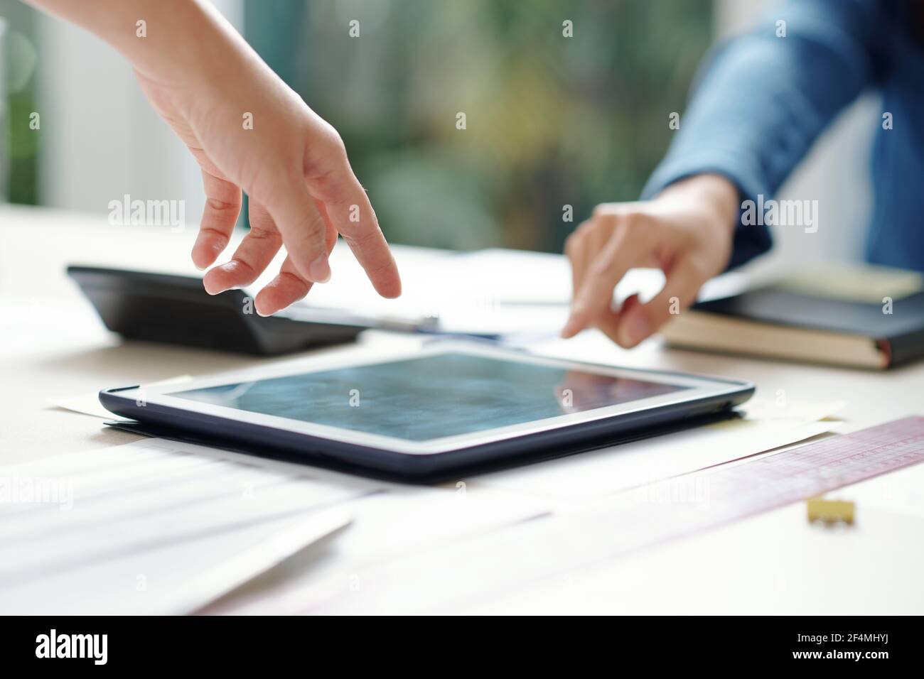 Close-up image of young entrepreneurs pointing at screen of digital ...