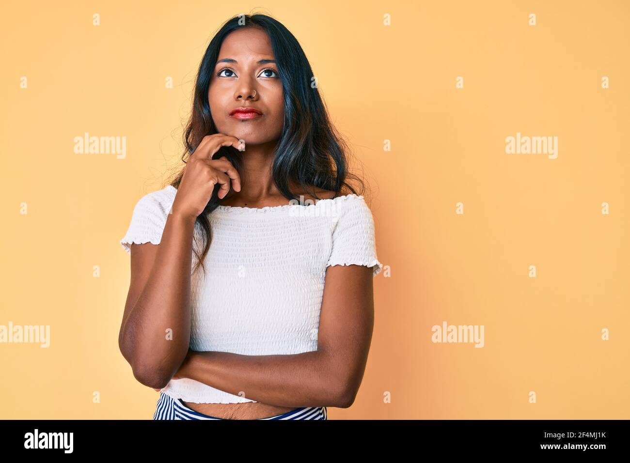 Young indian girl wearing casual clothes serious face thinking about ...